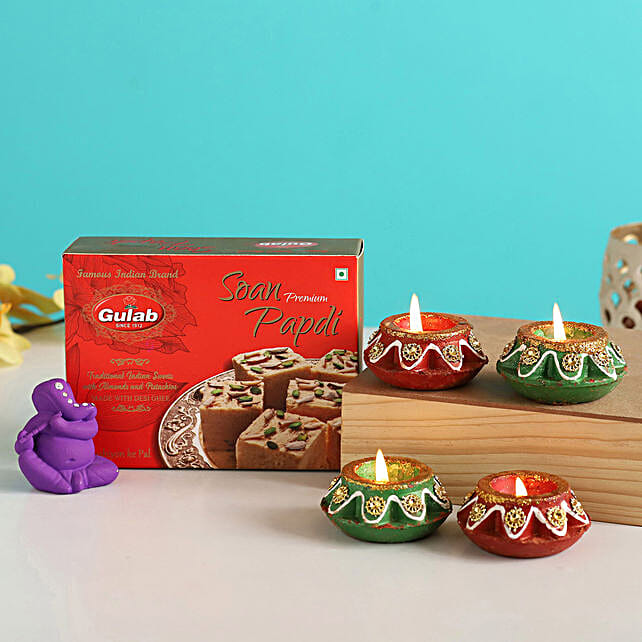 Buy/Send Purple Ganesha Idol With Soan Papdi & Diyas Online- FNP