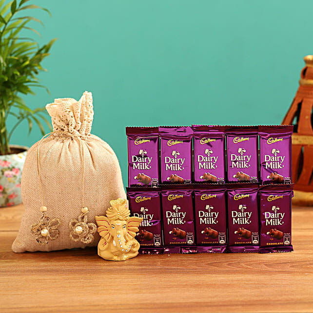 Buy/Send Beige Ganesha Idol & Dairy Milk In Fancy Potli Online- FNP