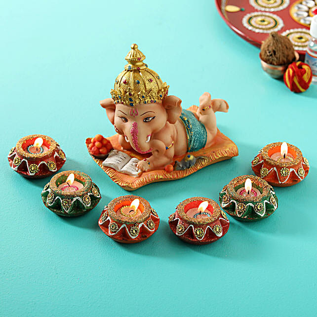 Buy/Send Reading Ganesha Idol & Matki Wax Diyas Online- FNP