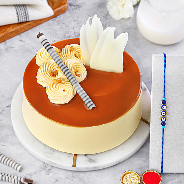 Buy/Send Minimalistic Navy Evil Eye Rakhi & Butterscotch Delight Online ...