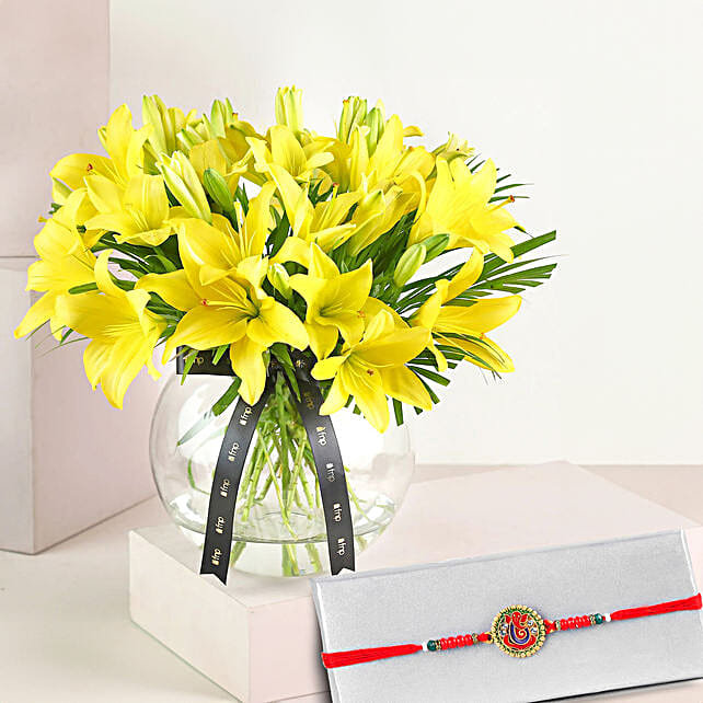 Buy/Send Ganesha Good Omen Rakhi N Sunshine Lilies Vase Online- FNP