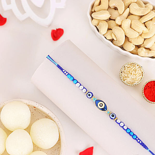 Buy/Send Evil Eye Rakhi & Sweets Combo Online- FNP