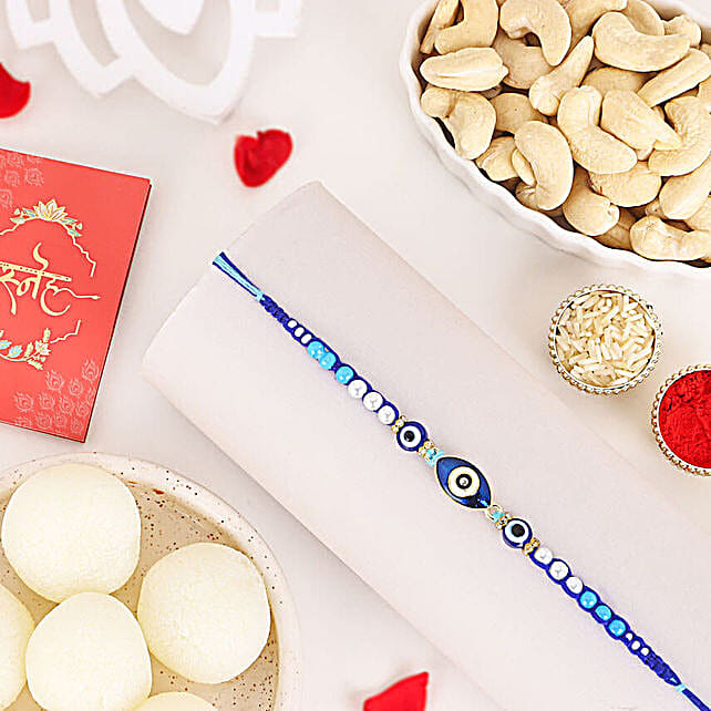 Evil Eye Rakhi & Sweets Combo oman | Gift Evil Eye Rakhi & Sweets Combo ...